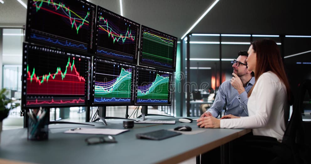 Stock Trader Analyzing Market Data on Multiple Monitors with Financial Graphs Stock Image ...