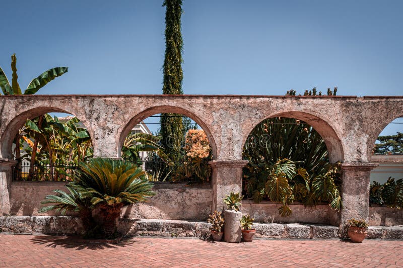Stone Arches Along Paved Sidewalk with Palm Trees on a Sunny Summer Day ...