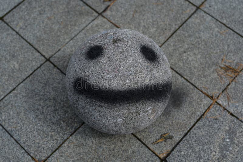 A Stone Ball with a Face Painted on it. Smiley Face Stock Image - Image ...