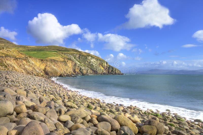 A Stone Beach With Cliffs In Background, Ireland. Stock Image - Image ...