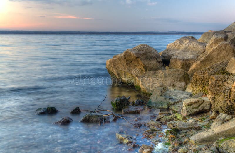 Stone beach at sunset stock photo. Image of beautiful - 66964398