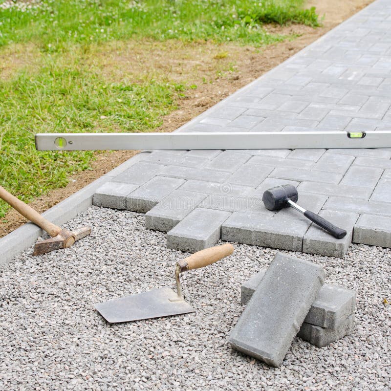 Stone Blocks with Tool for Paving Laying Down Background. Hausework ...
