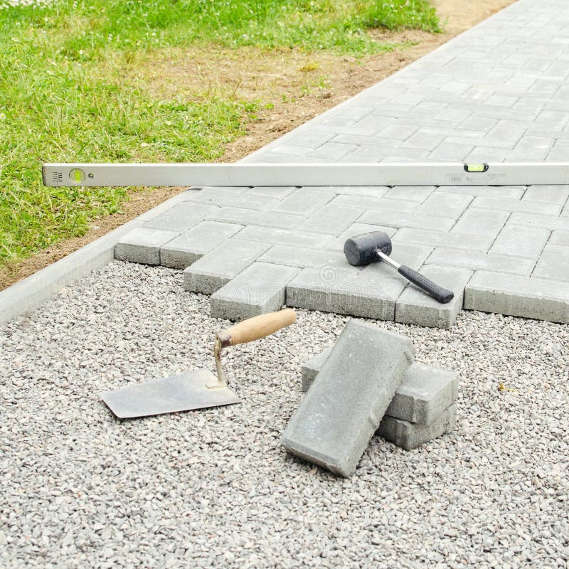 Stone Blocks with Tool for Paving Laying Down Background. Hausework ...