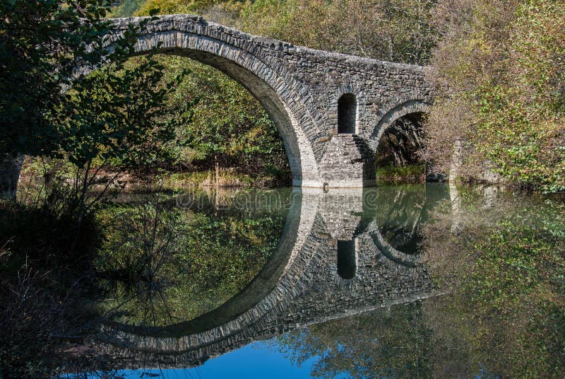 Very Old Stone Bridge Over the Quiet Lake with Its Reflection in the ...