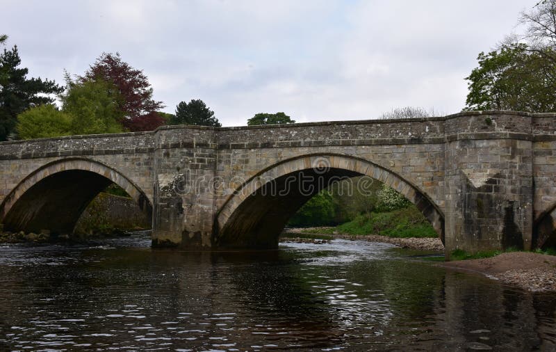 Old Stone Bridge with Arches Over a River Stock Photo - Image of stream ...