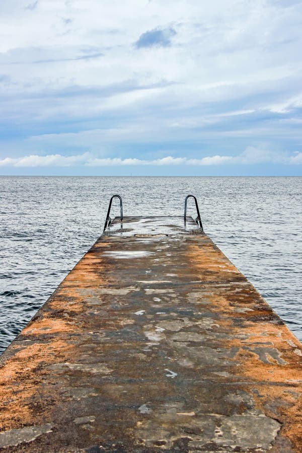 Bridge with Ladder on Ocean Stock Photo - Image of outdoor, stone ...