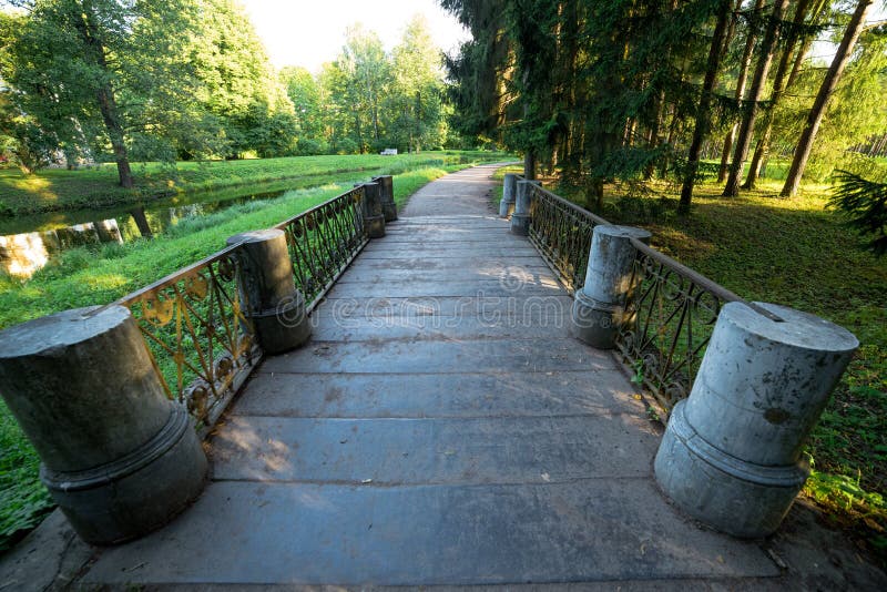 A Stone Bridge Over a Dried-up River and Green Grass in the Park. Stock ...