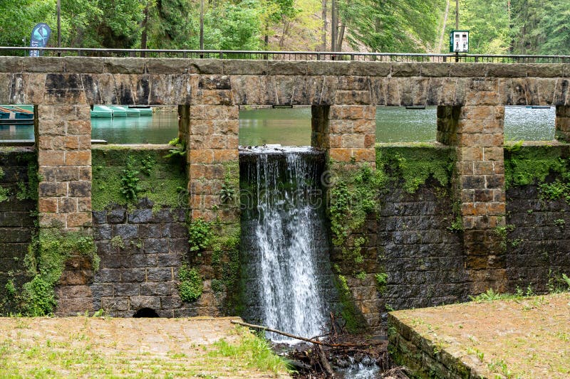 A Stone Bridge with a Small Waterfall on it Stock Image - Image of ...