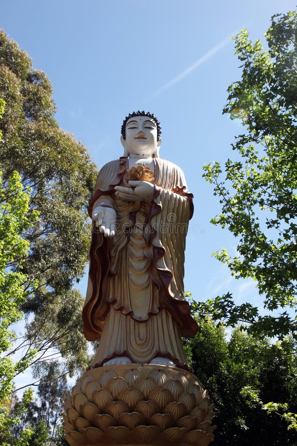 Buddha Statue Sitting Down with Legs Crossed in Prayer Stock Image ...
