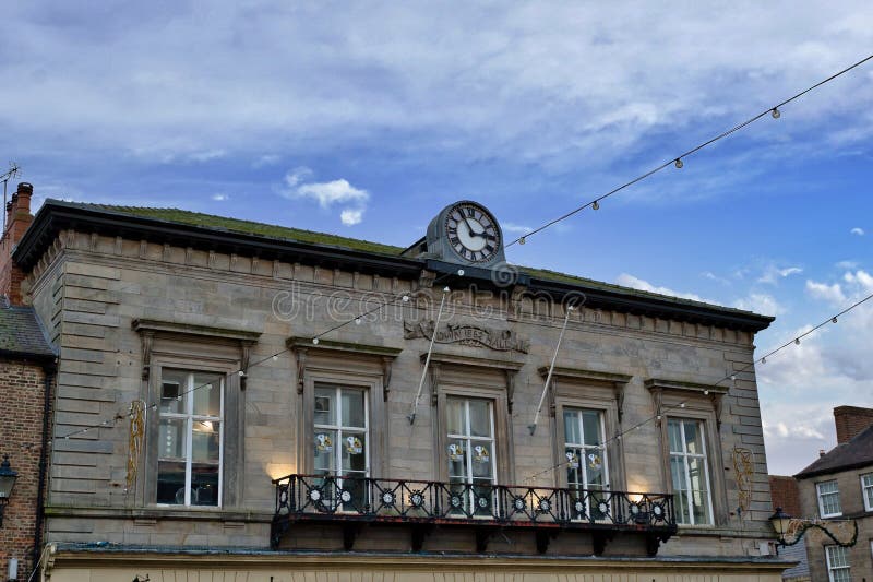 Stone Building Facade with Clock and Balcony Stock Photo - Image of ...