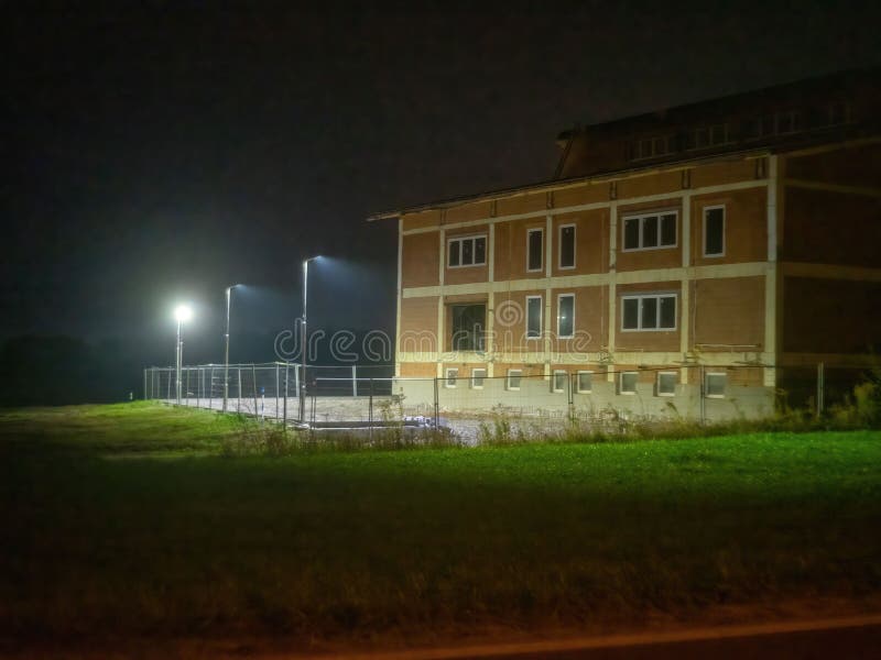 Stone Building Illuminated by Street Lamps at Night. Stock Photo ...