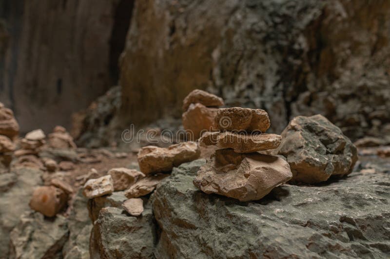 Stone Cairns Arranged Inside Cave Corridor with Arched Stone Formations ...