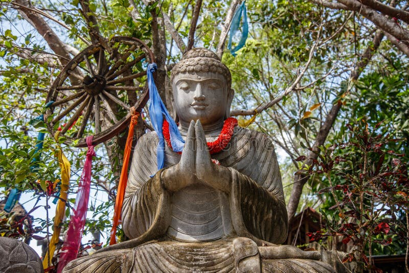 Stone Statue of Sitting Buddha Under the Tree, Bali, Indonesia. Stock ...