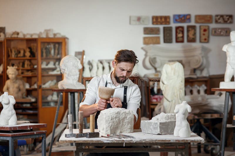 Stone Carver Works with Wooden Hammer and Chisel at Limestone. Stock ...