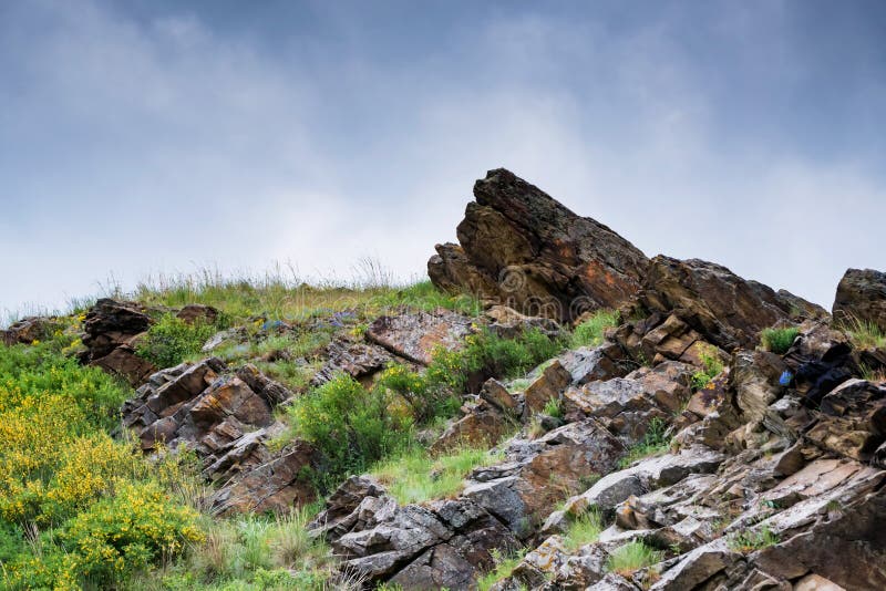 Stone Cavern in Green Steppe Landscape View with Cloudy Sky and Steppe ...