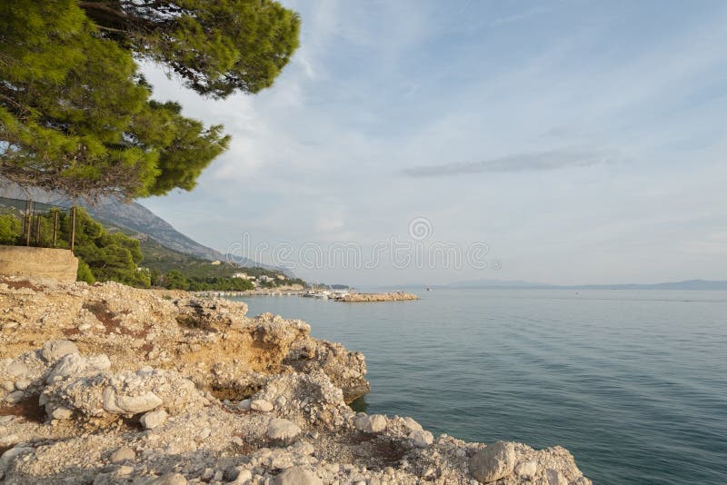 Stone Cliff Overlooking the Sea and Beach Stock Image - Image of legs ...