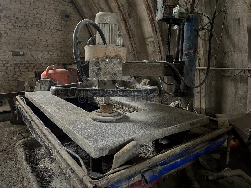 A Stone-cutting Machine in an Industrial Workshop, Surrounded by Dust ...