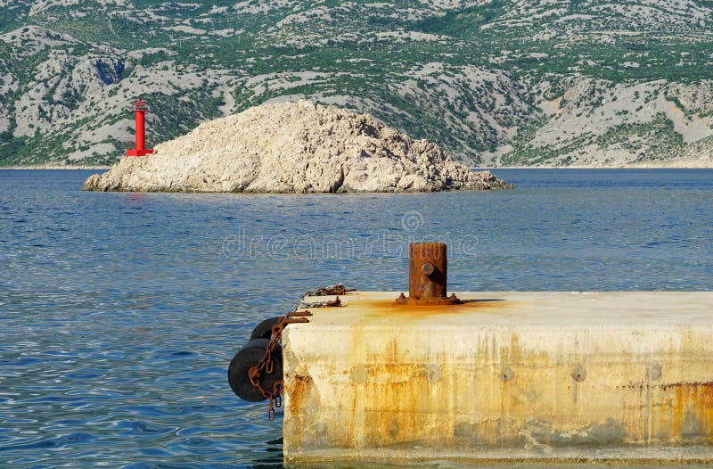 Stone Dock with a Rusty Mooring in Front of the Island of Zigljen and ...