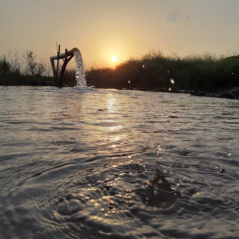 Stone Dropping in Water at the Sunset Stock Image - Image of wall ...