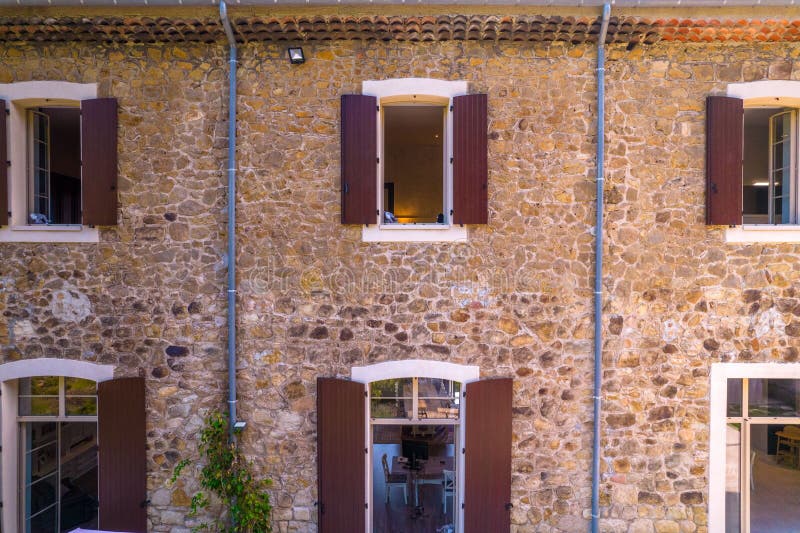 Stone Facade of a Large House with Six Open Windows on Two Floors, Two ...