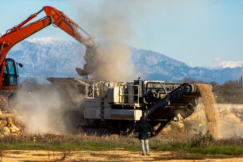 Stone Filled Rock Crusher with Stone Crusher and Bucket Editorial Image ...