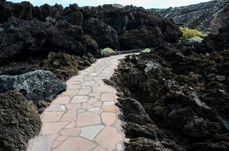 Stone Footpath Surrounded by Dark Rocks. Stock Photo - Image of surface ...