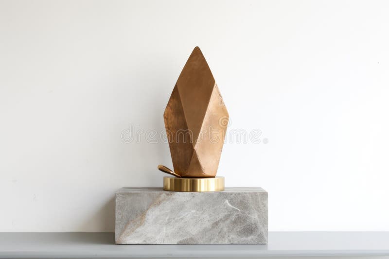 Stone and Gold Award Trophy on a White Shelf Stock Photo - Image of ...