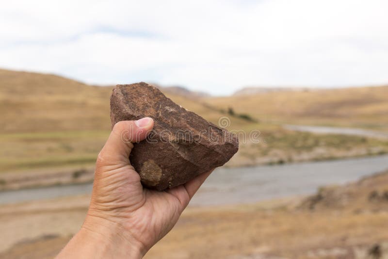 Stone in hand on nature stock image. Image of fingers - 111935525