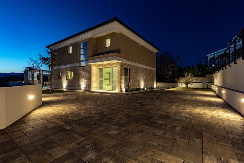 Stone House and Driveway Lit Up at Night Editorial Image - Image of ...