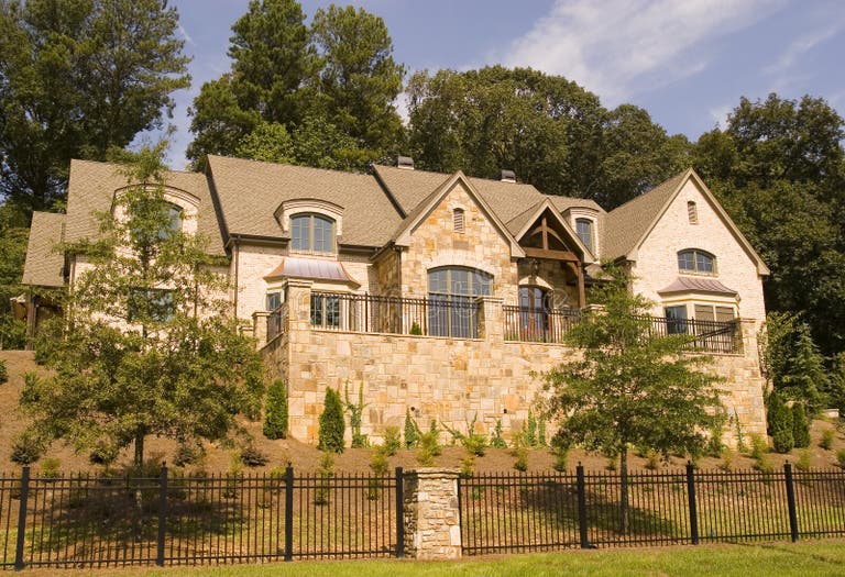 Stone House and Wrought Iron Stock Image - Image of landscaping ...