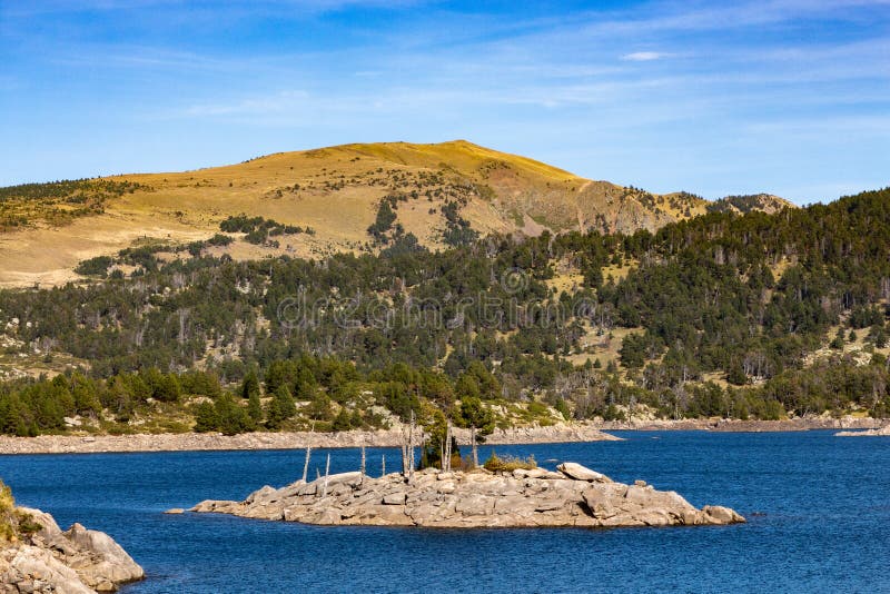 Stone Island in Blue Lake and Mountains in the Background Stock Photo ...