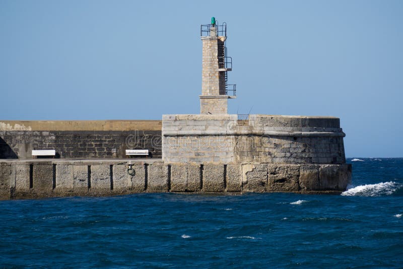 Stone Lighthouse Over Ocean and Blue Sky Stock Image - Image of ...
