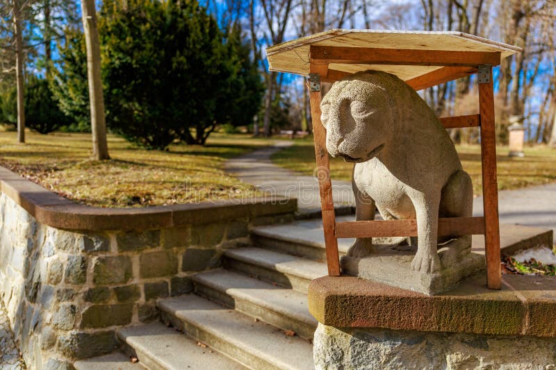 Stone Lion Statue in Park with Shelter on Sunny Day Stock Photo - Image ...