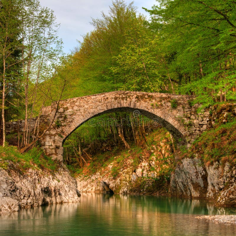 Very Old Stone Bridge Over the Quiet Lake with Its Reflection in the ...