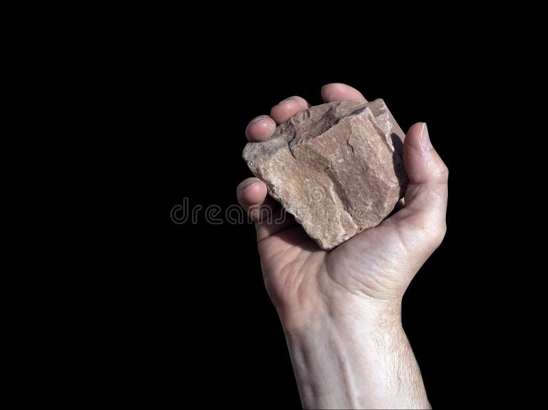 Stone in a Man’s Hand, Against the Background of a Gray Concrete Wall ...