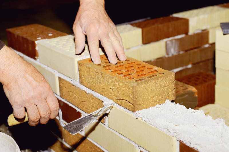 Mason laying brick stock photo. Image of tradesman, brick - 2112276