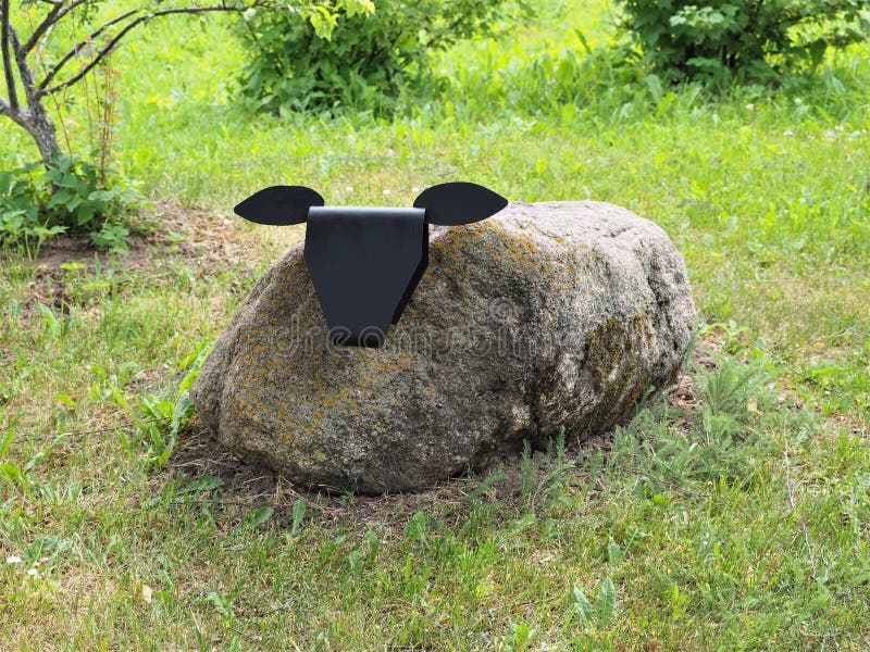 A Stone with a Metal Sheeps Head Stock Photo - Image of sheep, design ...