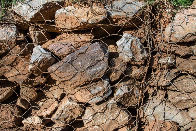 Stone in metallic net stock image. Image of construction - 48284895