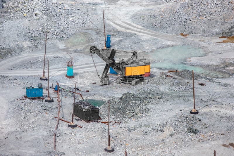 Stone Open Pit. Excavator is Loading Raw Materials into Yellow Truck ...