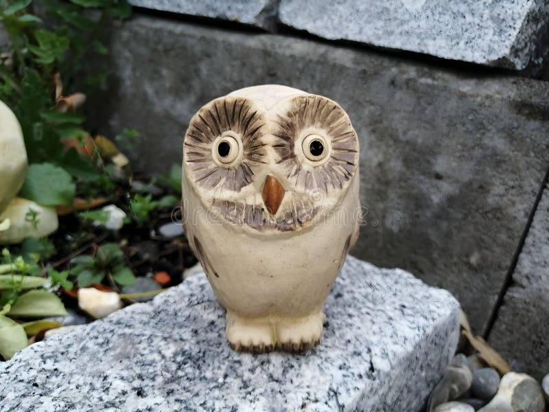 Stone Owl Sculpture in a Garden Setting among Rocks Stock Photo - Image ...