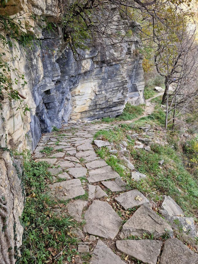 A Stone Path Cuts through the Side of a Large Hill Stock Photo - Image ...