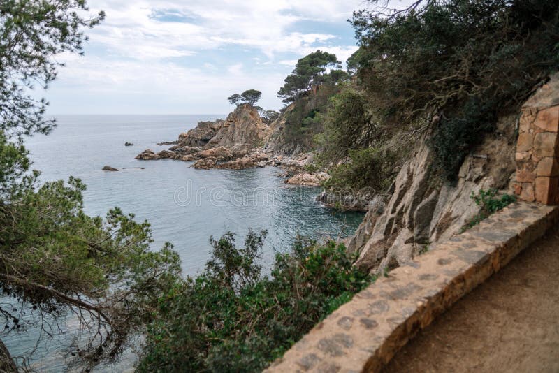 A Stone Walkway Leading Down the Side of a Hill To an Ocean Stock Photo ...