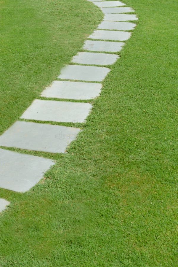 Stone Pathway Along a Grass Lawn or Garden Stock Image - Image of ...