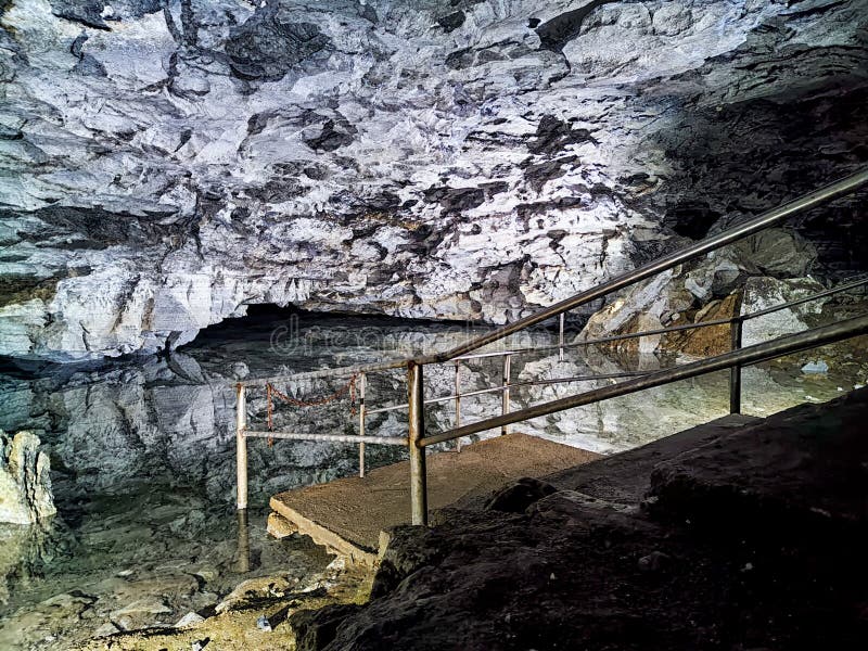A Stone Pathway Winds through a Cave, Illuminated by Artificial ...