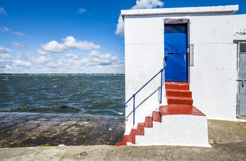 Stone Pier with a Small Building on it Stock Photo - Image of water ...