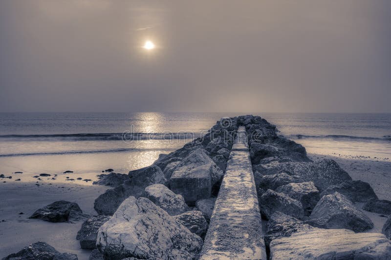 Stone pier at sunrise. stock photo. Image of tranquil - 12636394