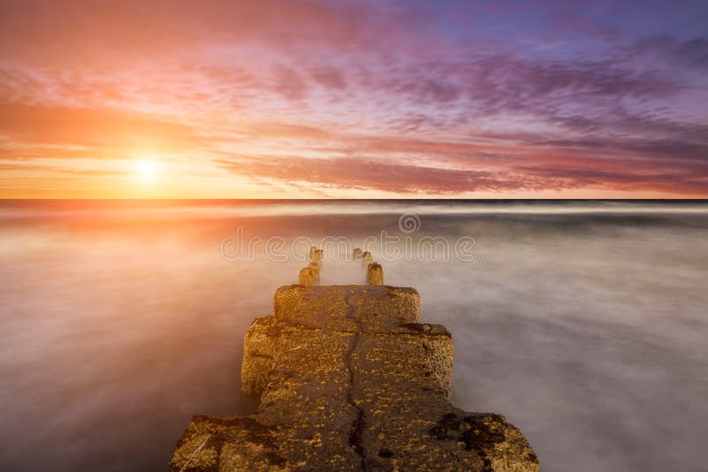 Stone pier at sunset stock photo. Image of outdoor, copy - 81956386