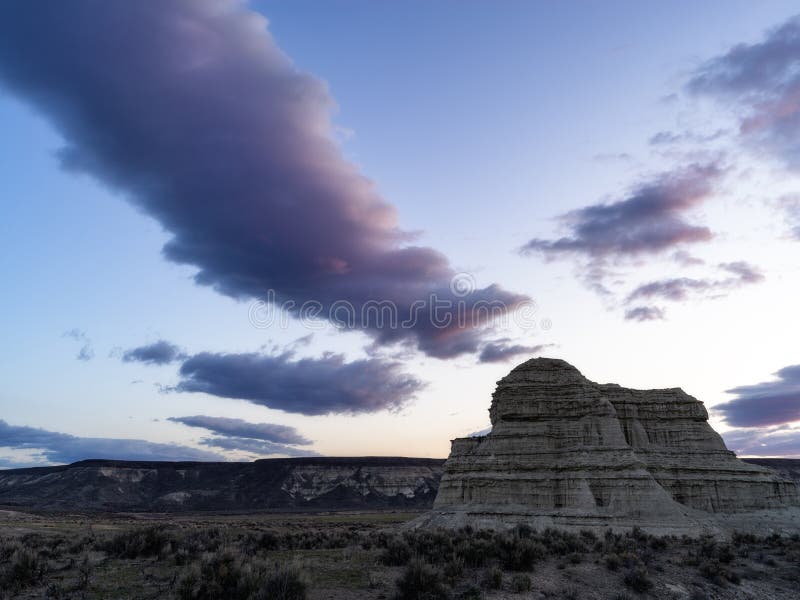 Stone Pillar at Sunrise with Elongated Clouds Above Stock Image - Image ...