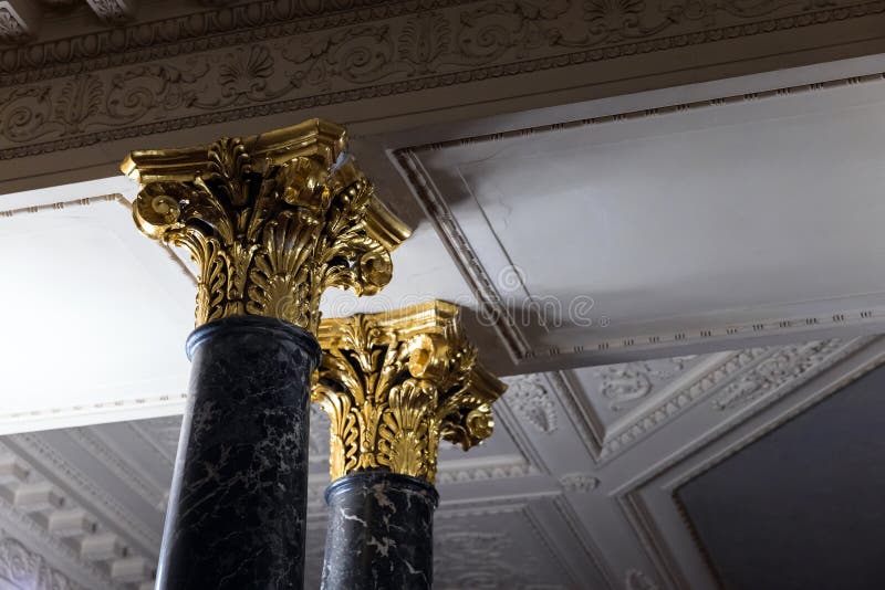 Stone Pillars with Gold Colored Capitals are Under White Ceiling Stock ...