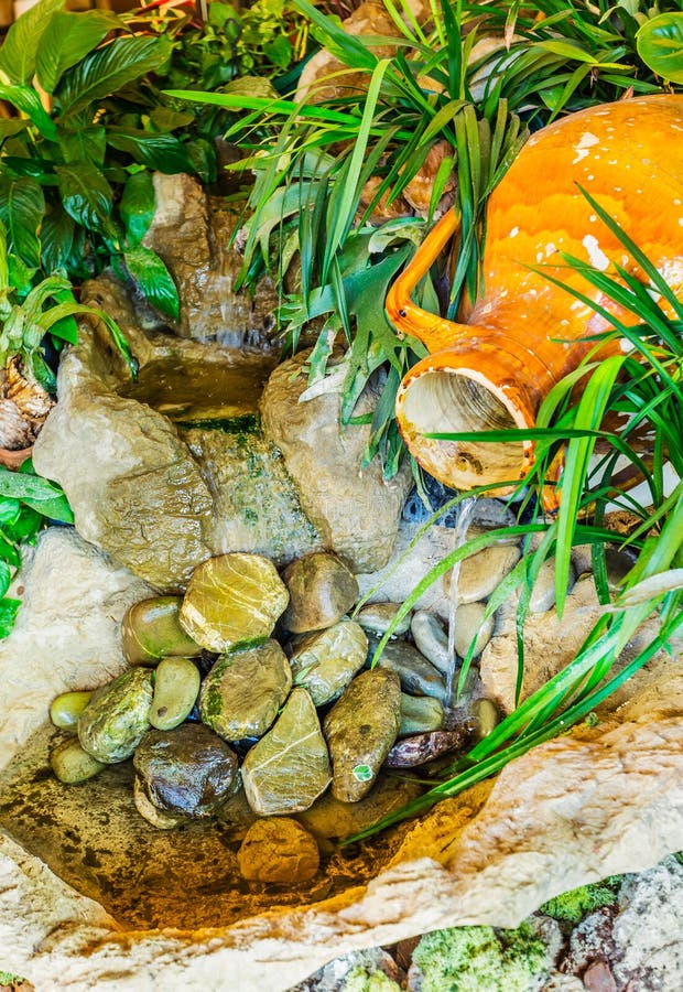 Stone pitcher of water stock photo. Image of waterfall - 197484284